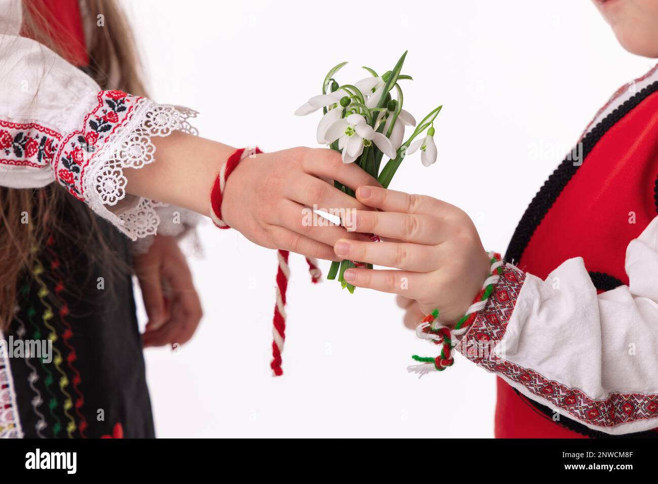 Bulgarian kids boy, girl in folklore ethnic costumes, bouquet spring ...