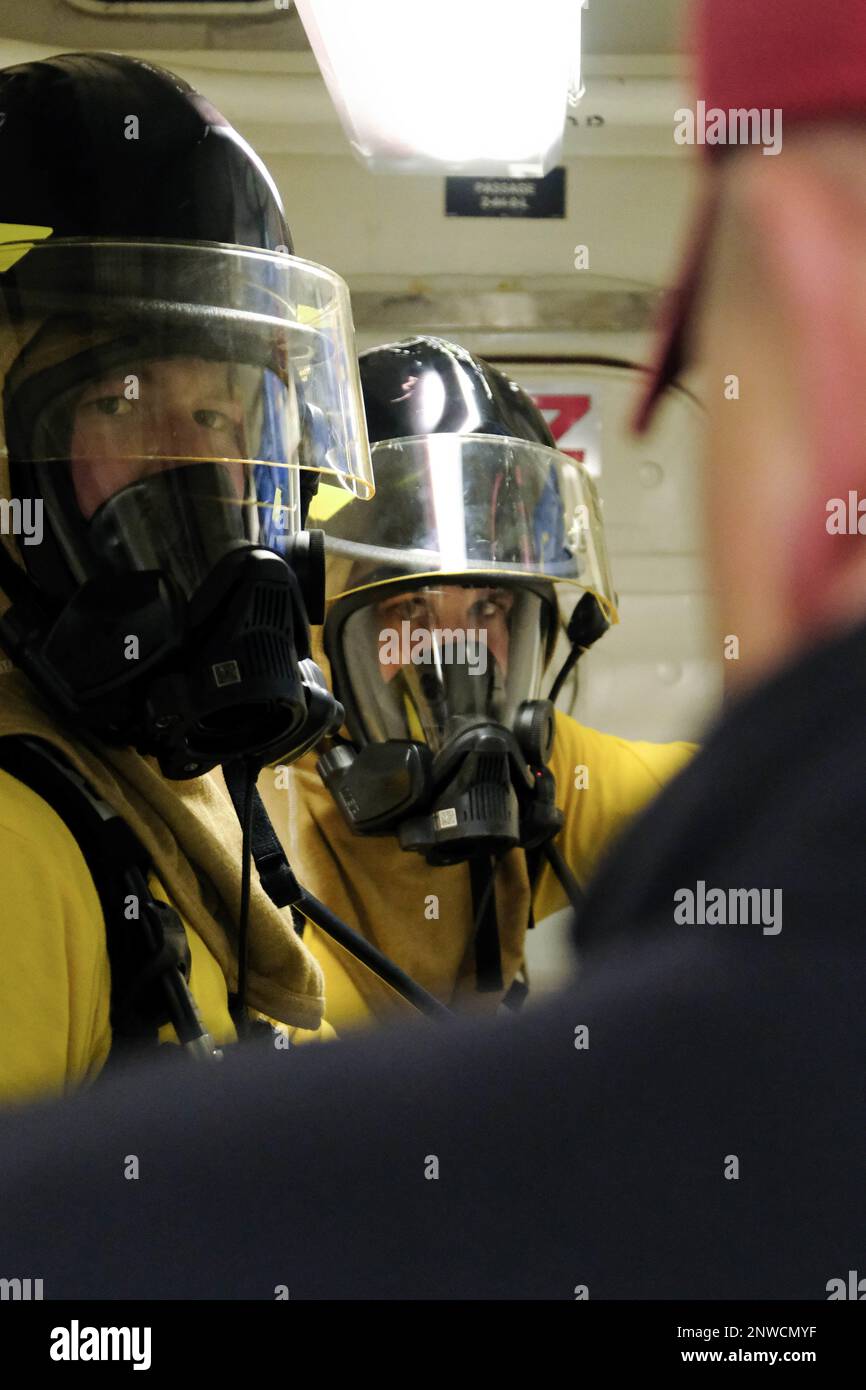 U.S. Coast Guard Petty Officer 2nd Class Jackson Ritchie (left), a ...