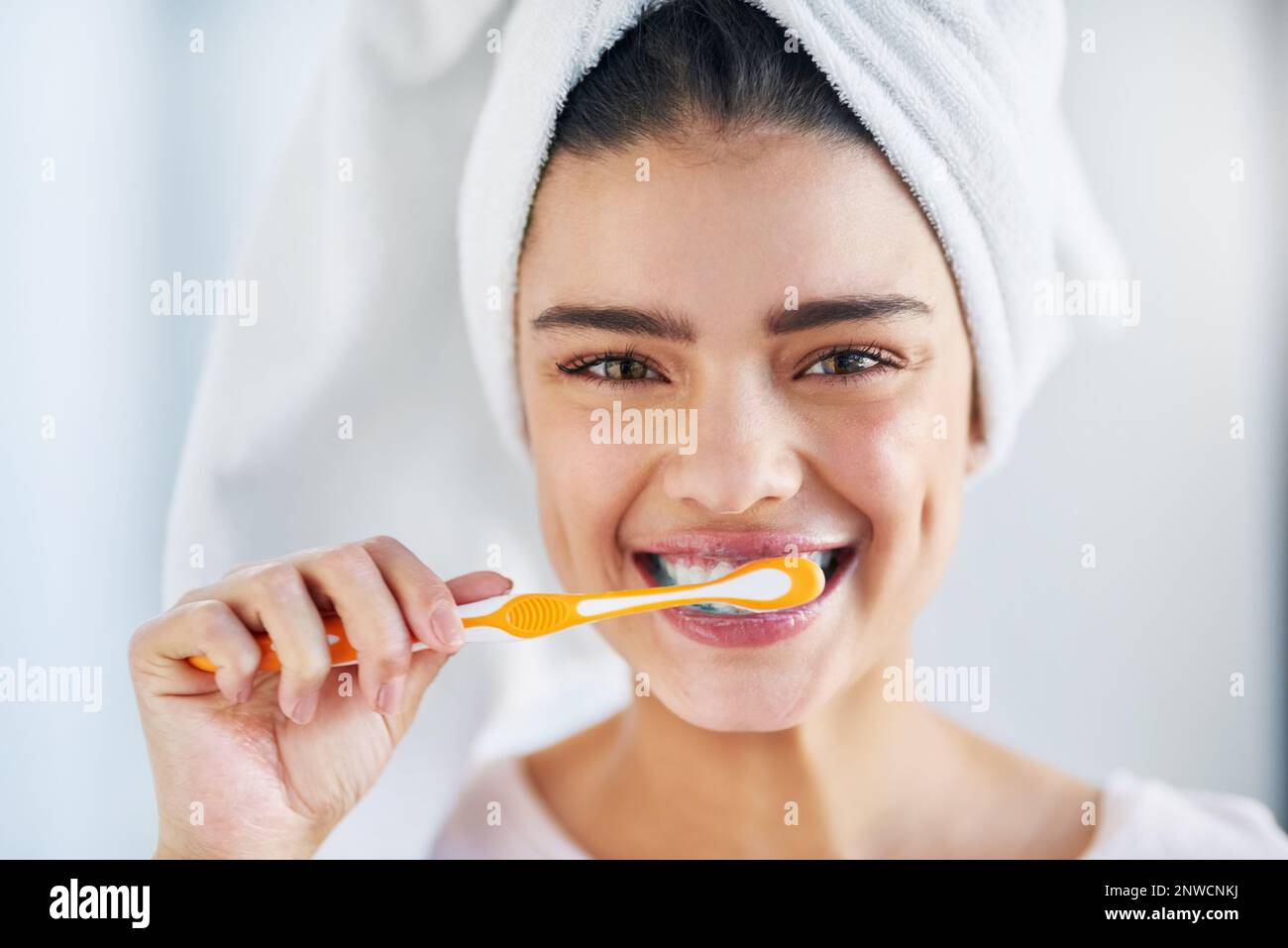 Oral hygiene comes first. Portrait of a beautiful young woman brushing ...