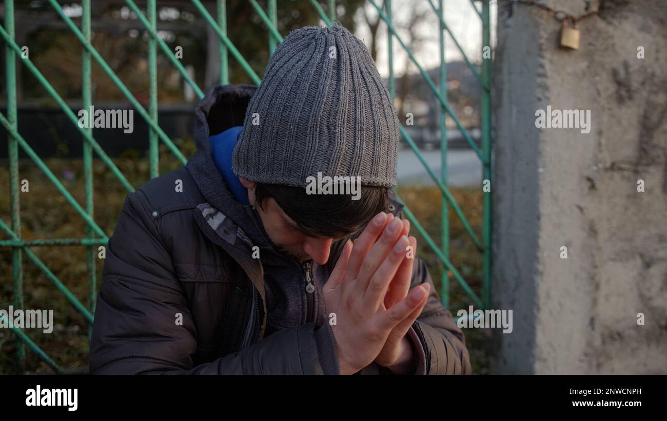 Young Faithful Man Praying to God in Front of Cemetery Stock Photo - Alamy