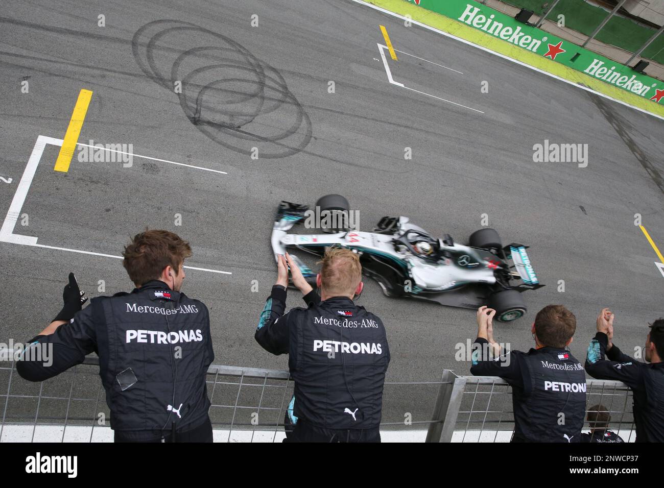 Members of the Mercedes Benz team cheer at driver Lewis Hamilton, of ...