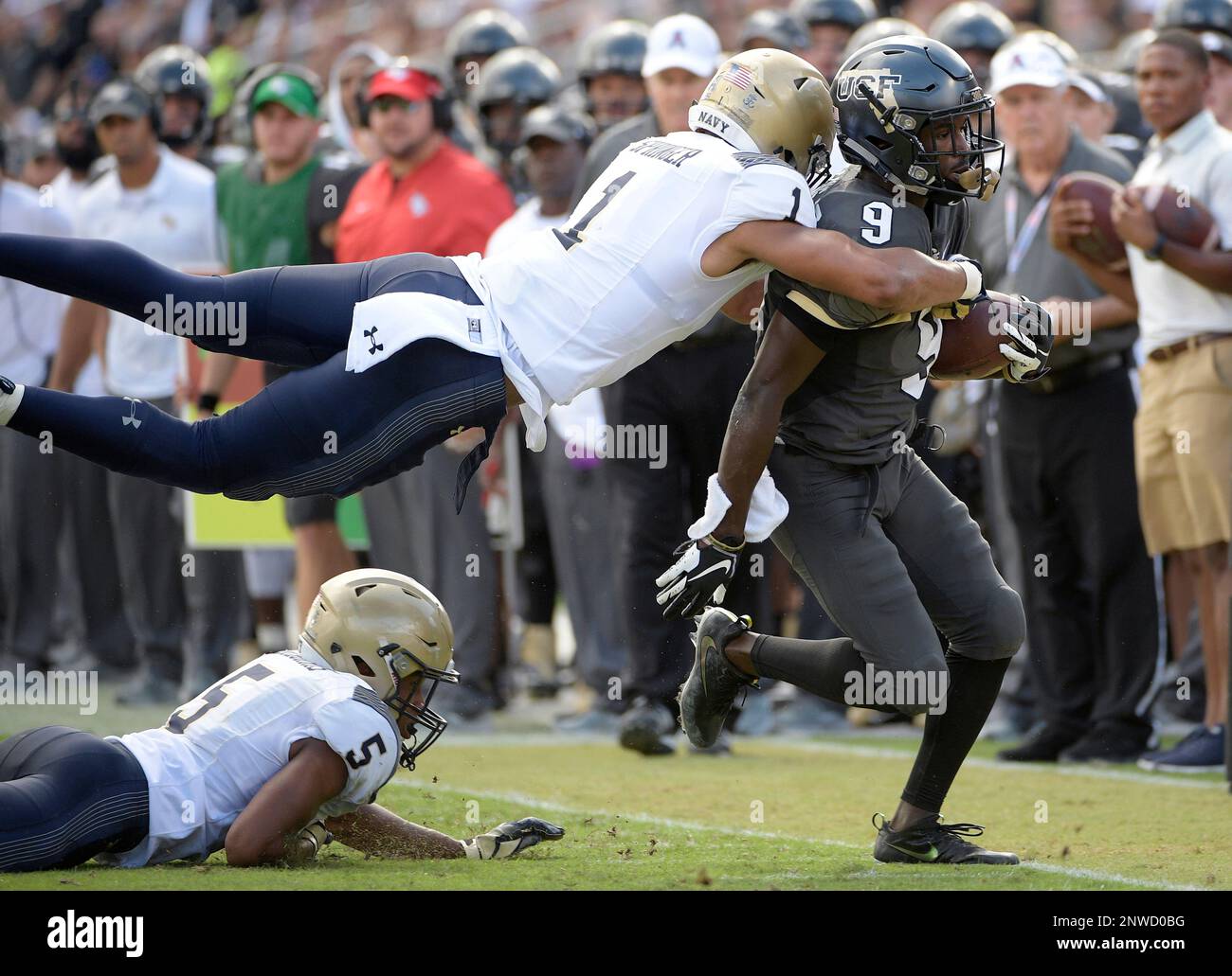Central Florida running back Adrian Killins Jr. (9) is tackled by Navy ...
