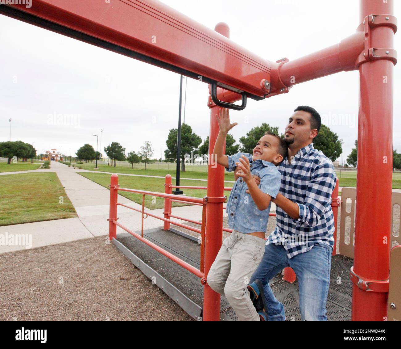 Rev. Aaron Zapata lifts his adopted son Kamdyn Zapata, 5, onto a ...