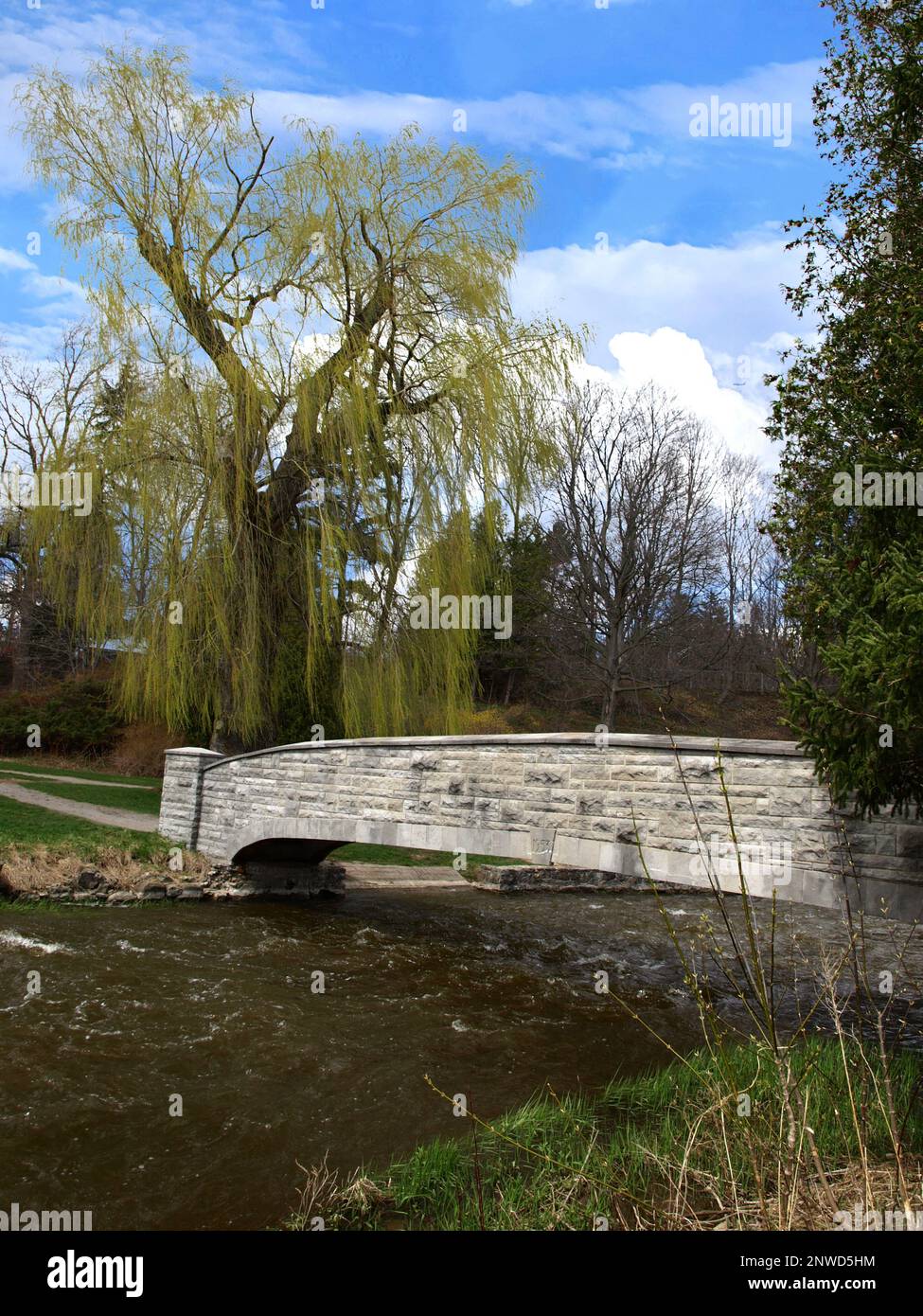 Bridge over a lazy river that flows from the water falls, Weber Falls ...
