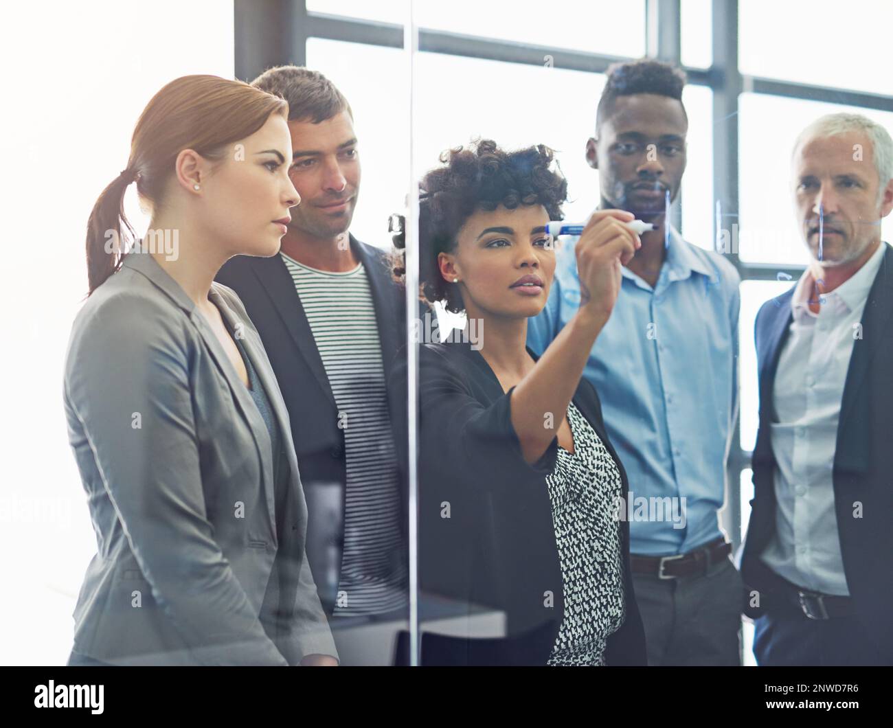 Prioritizing tasks for their team project. Shot of a group of ...