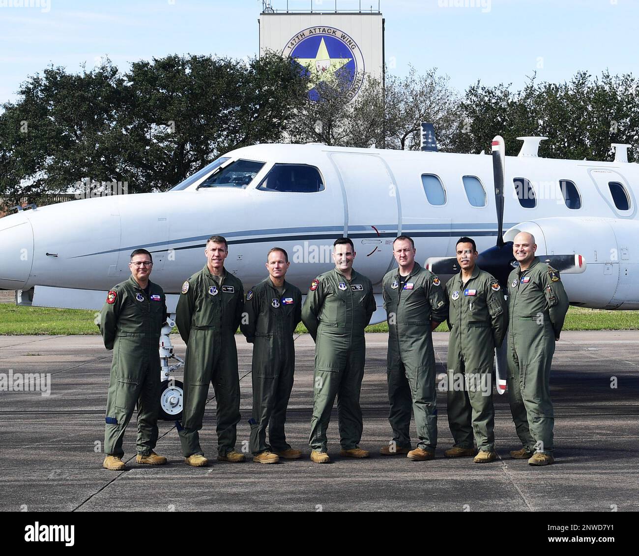 RC-26 crew members pose in front of the 147th Attack Wing's Condor ...
