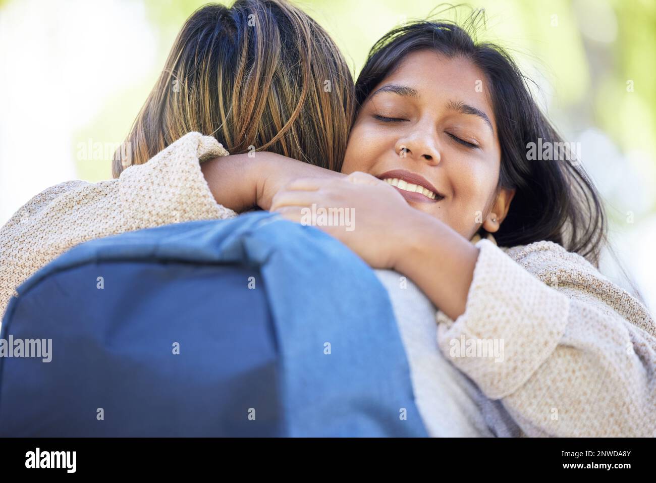 Happy students, backpack and hug in park, garden or school campus bonding, friends acceptance or ...