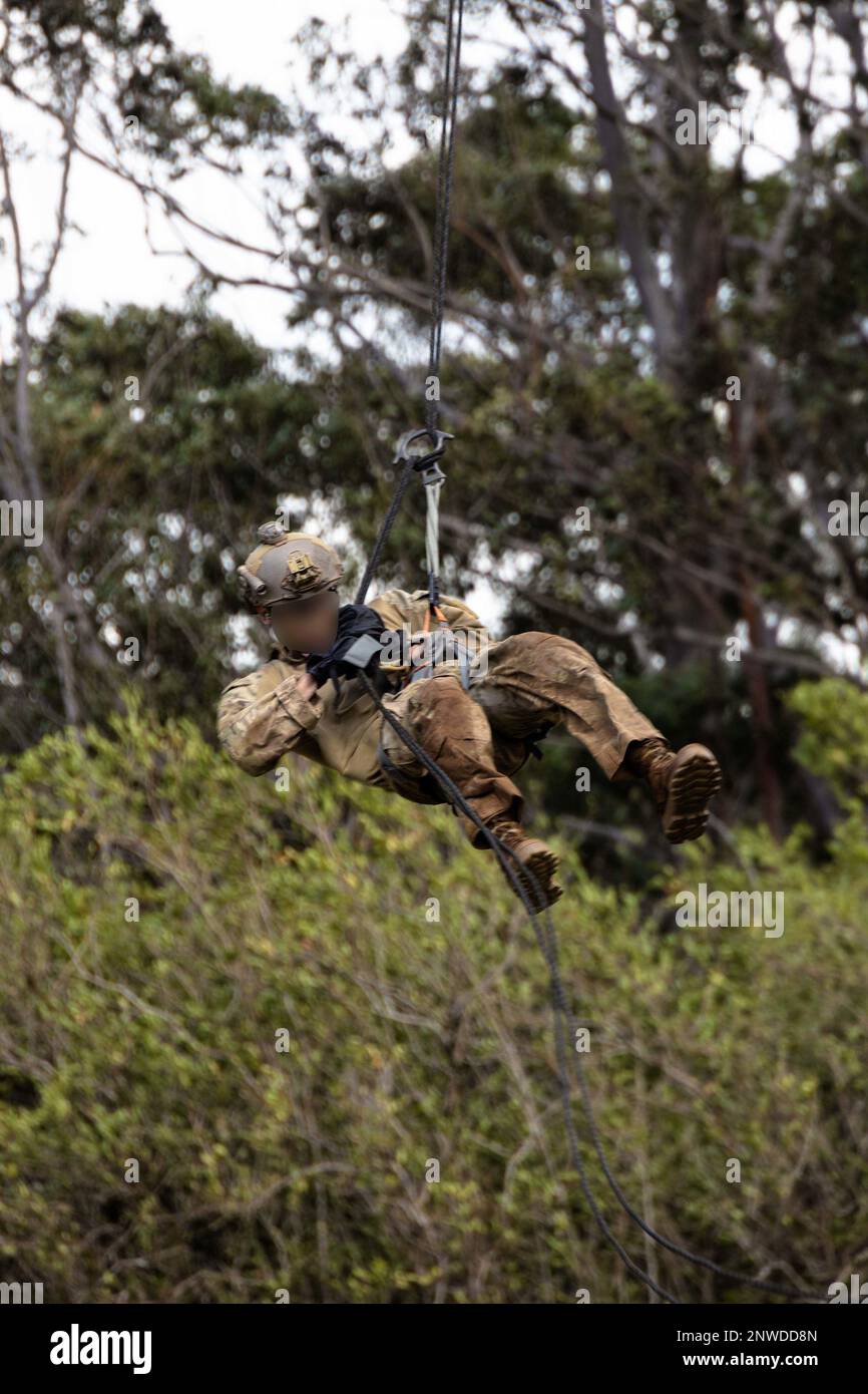 A U.S. Marine with Marines Forces Special Operations Command rappels ...