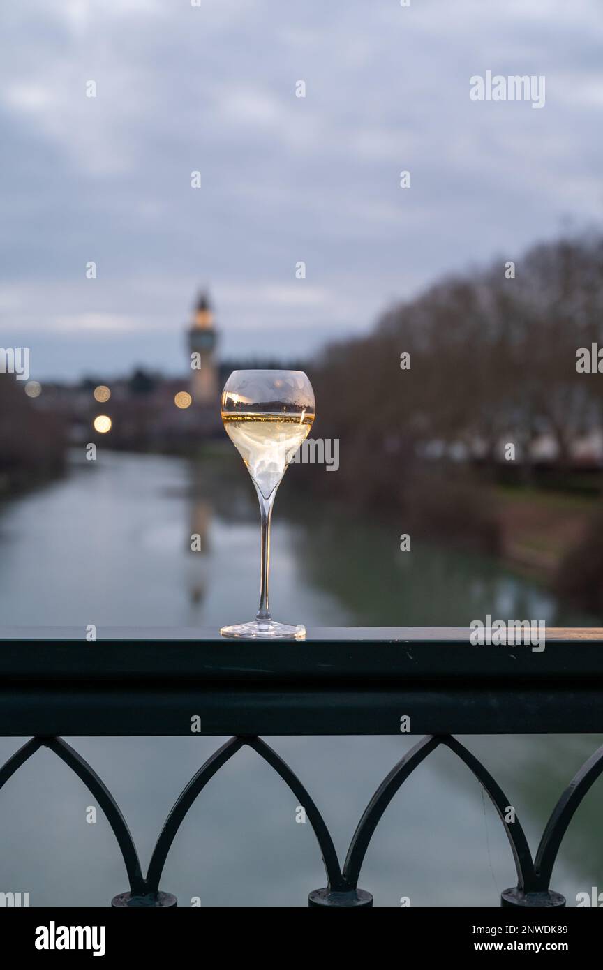 Glass of french sparkling white wine with bubbles champagne outdoor ...