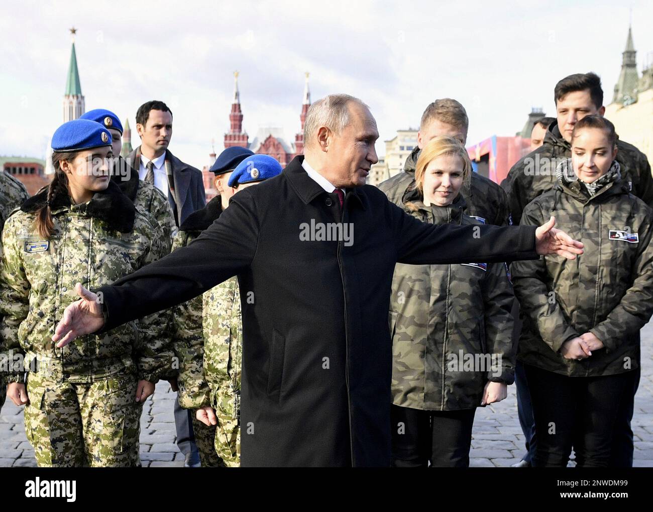 Russian President Vladimir Putin Center Gestures As He Poses For A