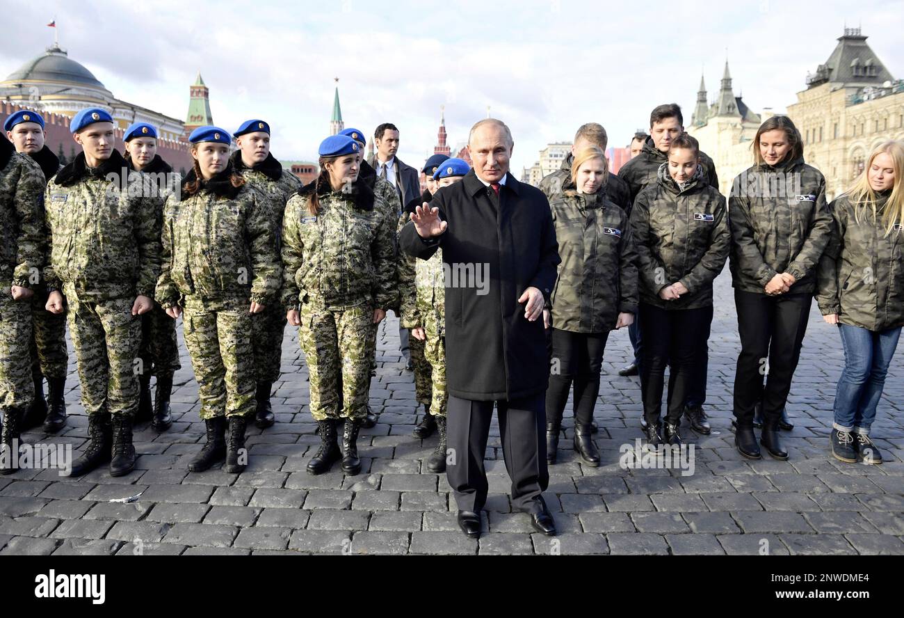 Russian President Vladimir Putin Center Gestures As He Poses For A