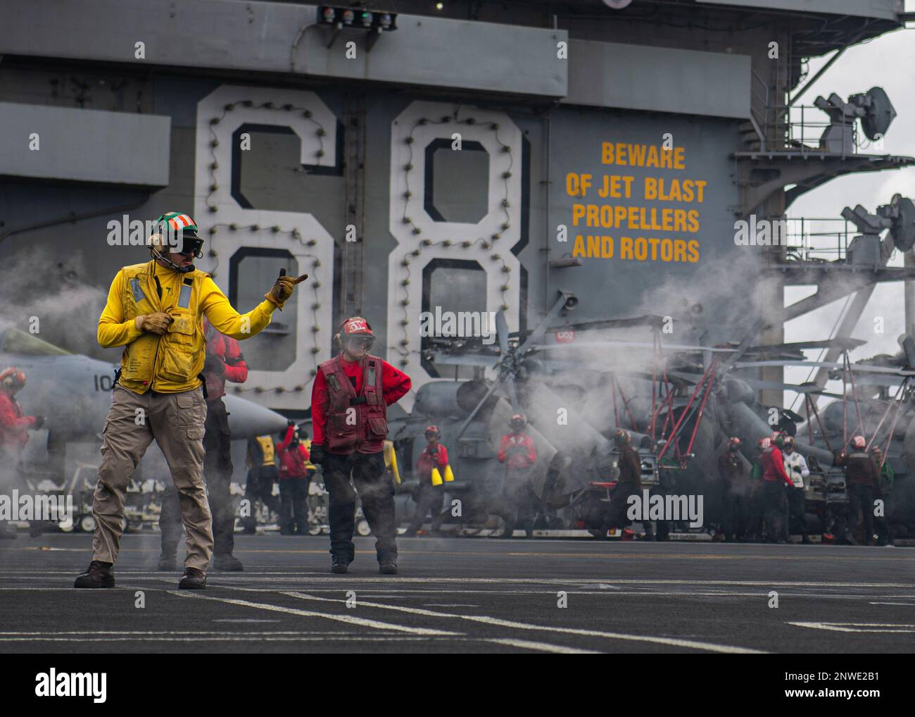 230105-N-MH015-1147 PHILIPPINE SEA (Jan. 5, 2023) A U.S. Navy Sailor directs aircraft on the ...