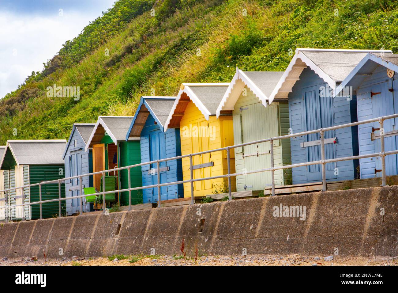 Traditional wooden beach huts on the promenade in the seaside town of ...