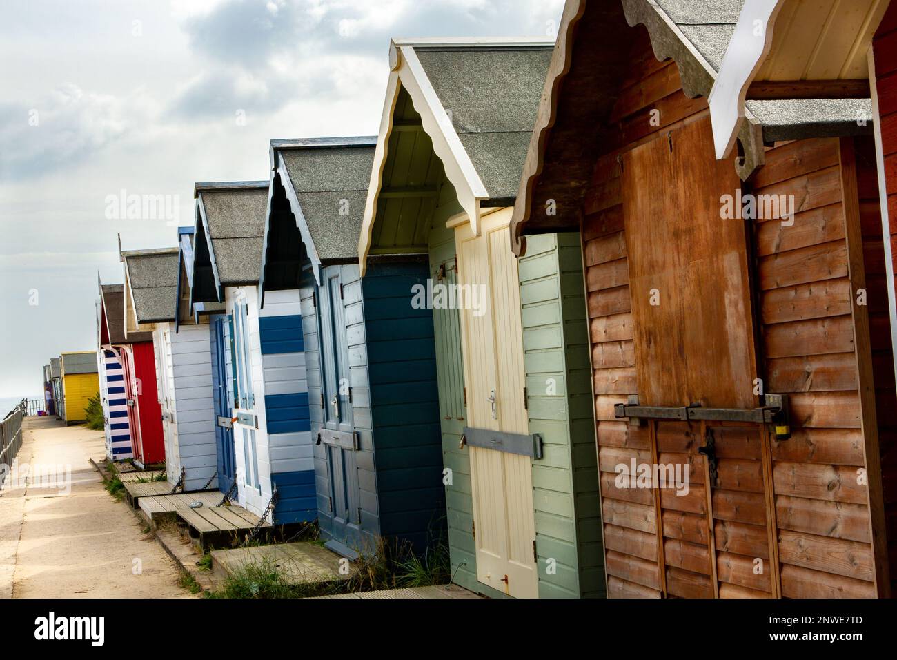 Traditional wooden beach huts on the promenade in the seaside town of ...