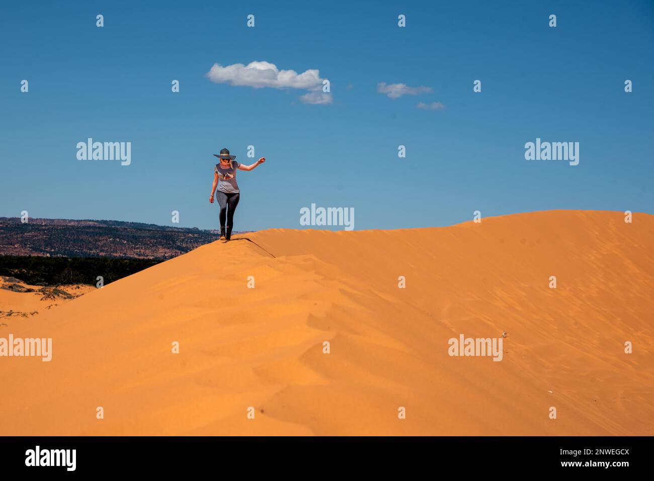 Woman walking through the Coral Sand Dunes State Park in Utah, United ...