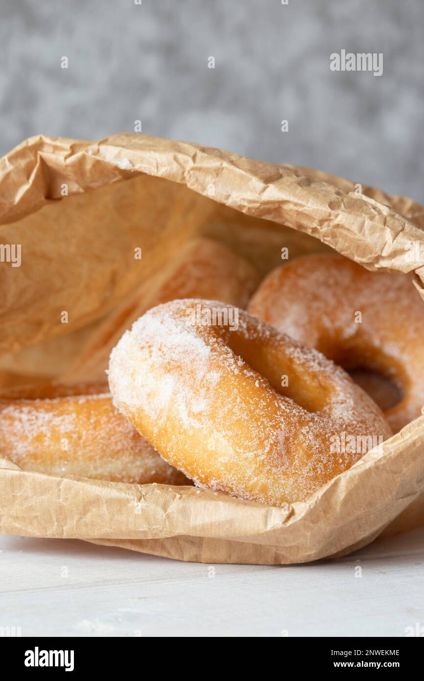 Ring doughnuts, or donuts, in a brown paper bag. Sustainable plastic ...