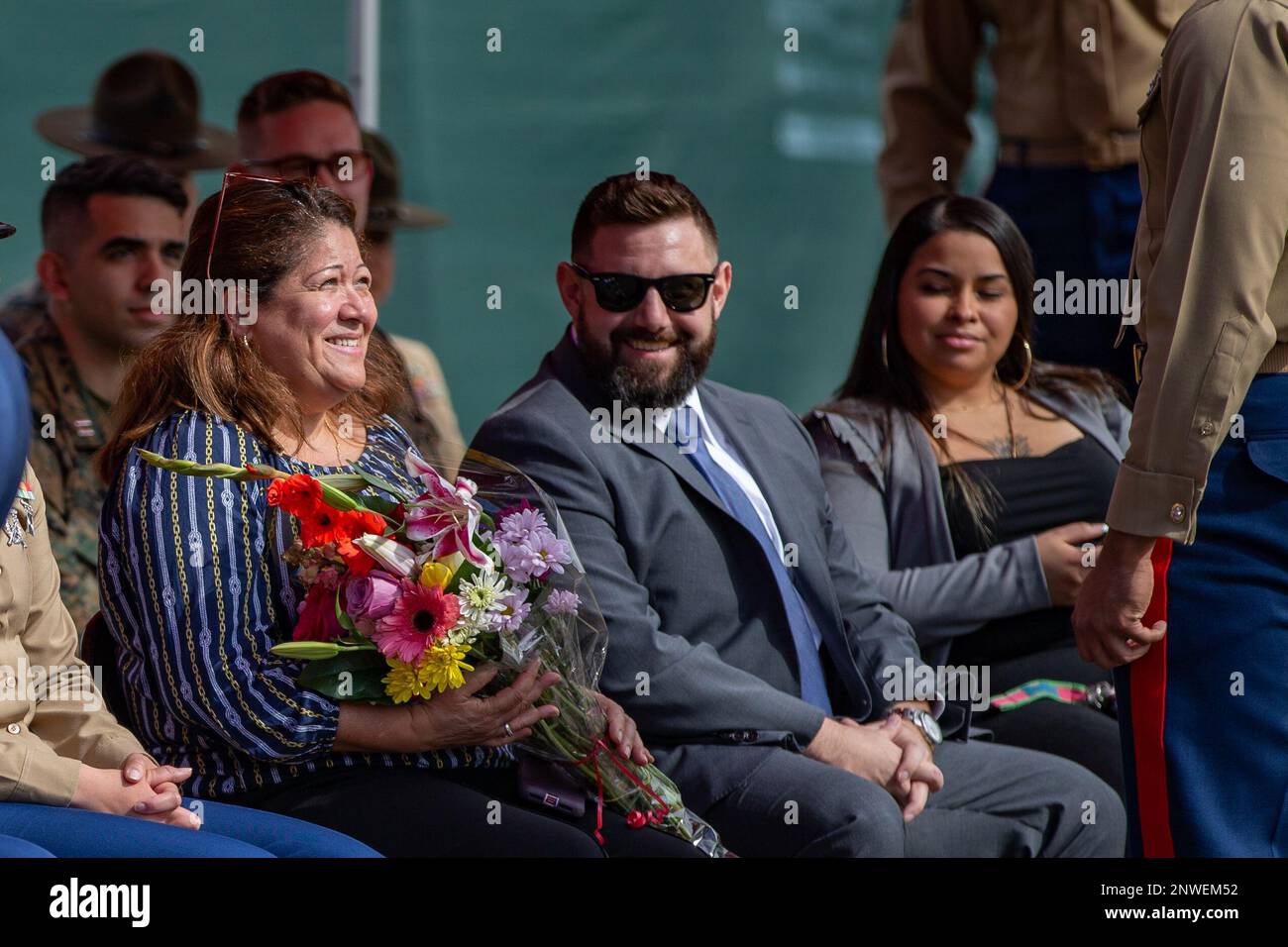 A guest of Capt. Mylen Morales receives flowers during a change of ...