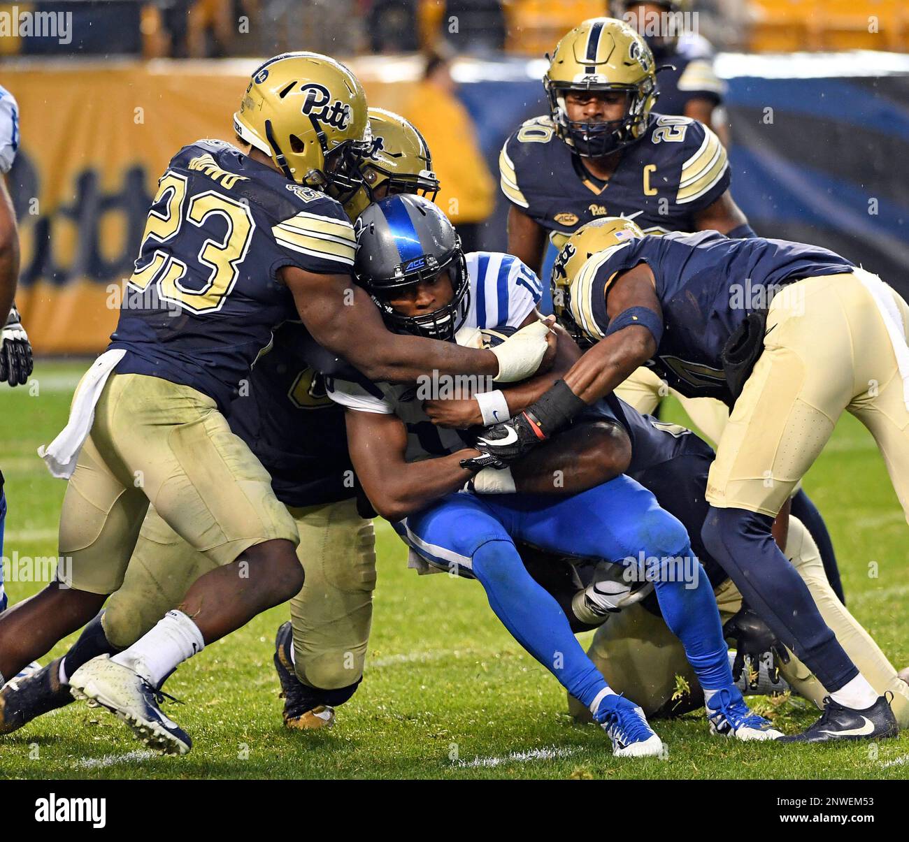 Pittsburgh's Oluwaseun Idowu (23) leads a host of defenders in stopping ...