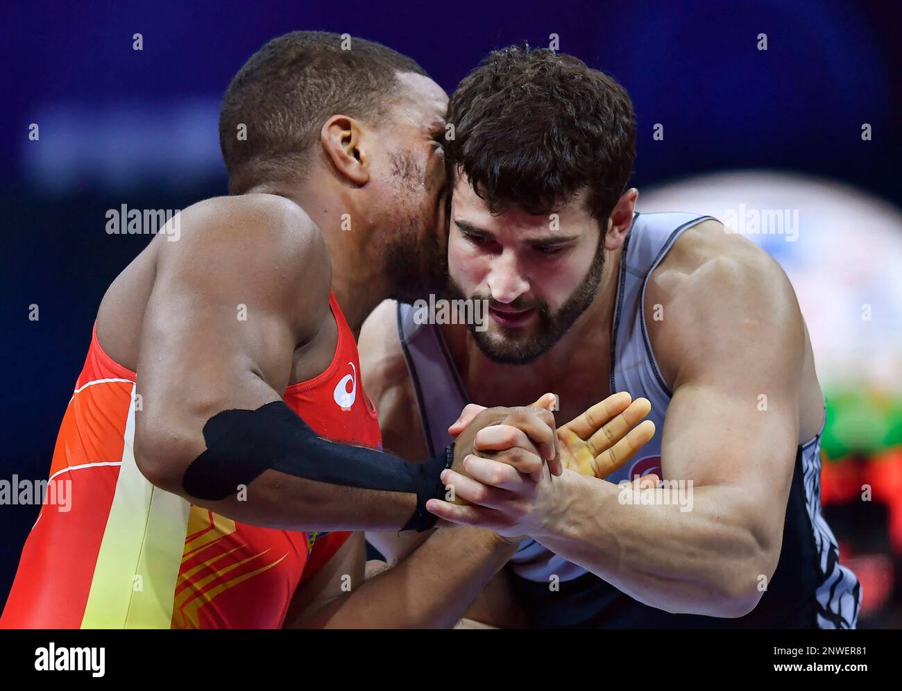 Metehan Basar of Turkey, in blue, wins against Zhan Beleniuk of Ukraine ...