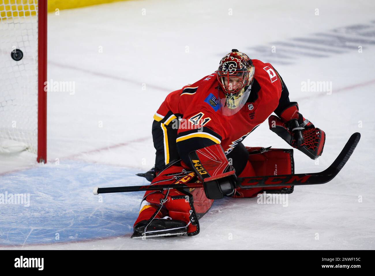 Calgary Flames goalie Mike Smith lets in a goal during NHL hockey game ...
