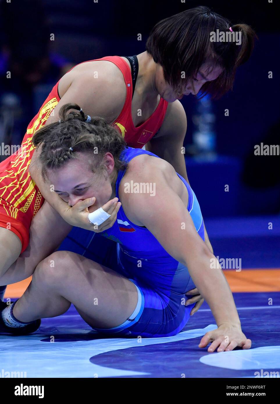 Xingru Pei, in red, of China wins against Svetlana Lipatova of Russia ...