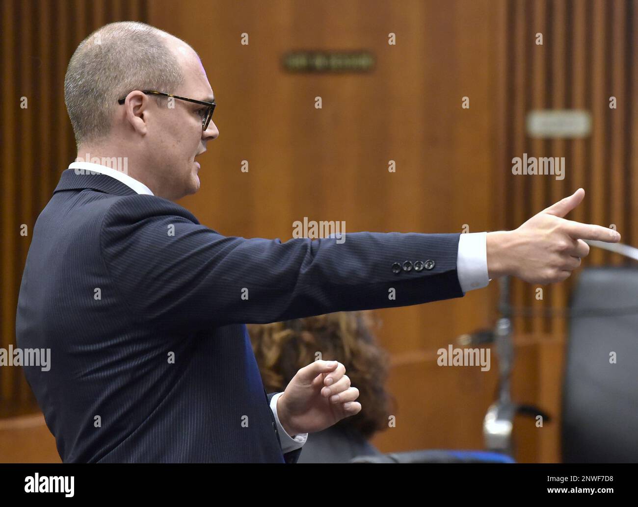 Assistant prosecutor Matthew Penney acts like he's pulling the trigger ...