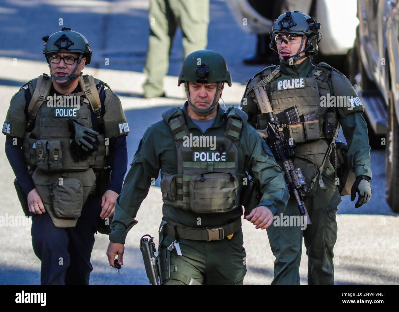 Gwinnett County police SWAT team members work in a neighborhood during ...