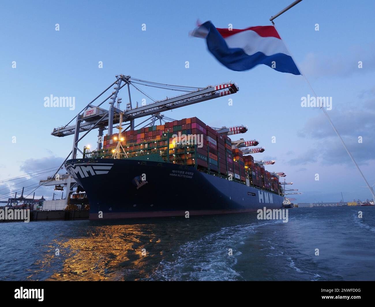 The container carrier HMM Rotterdam moored at the terminal in the ...