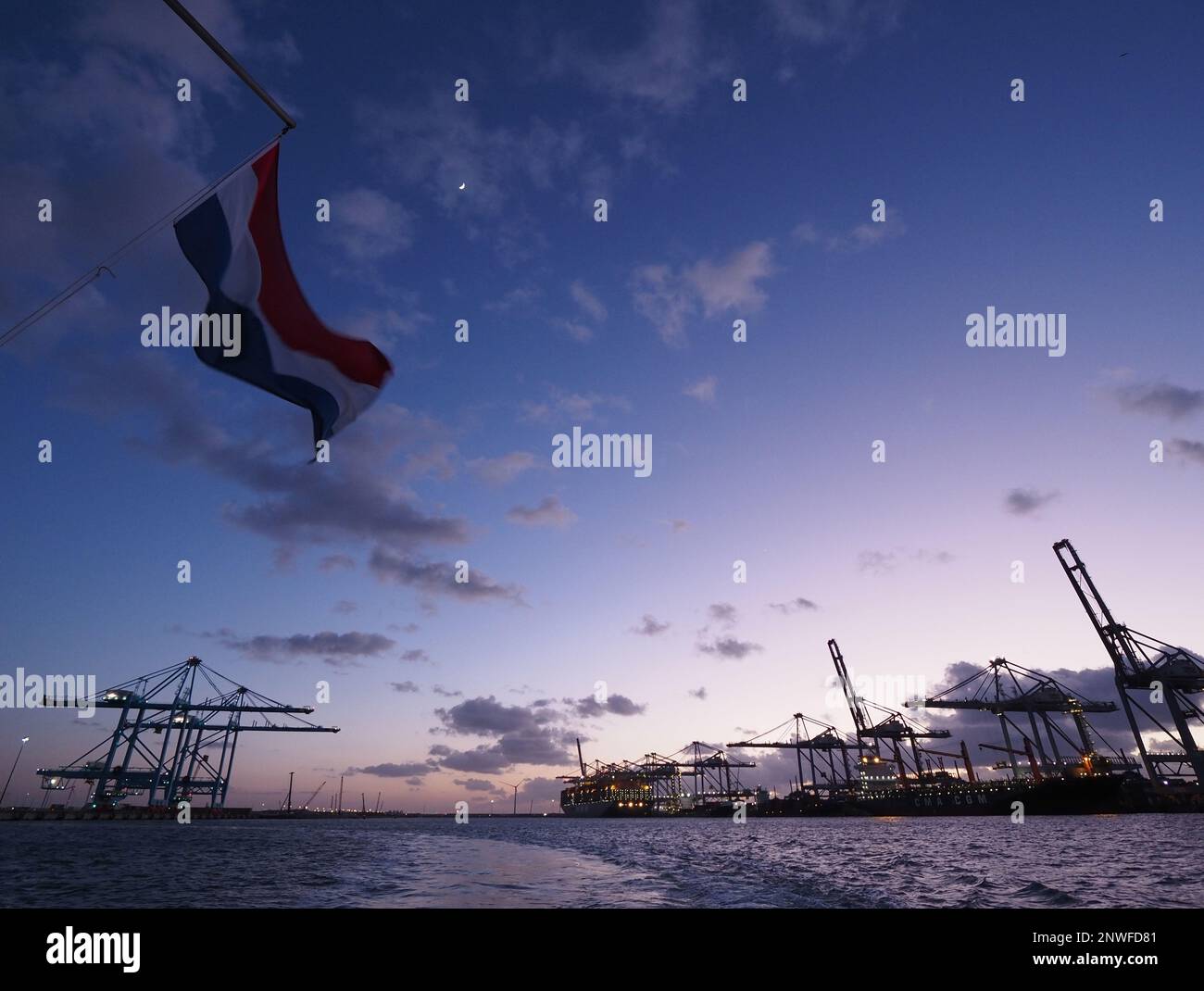 Nightfall in the deep sea port of Rotterdam, the Netherlands with ...