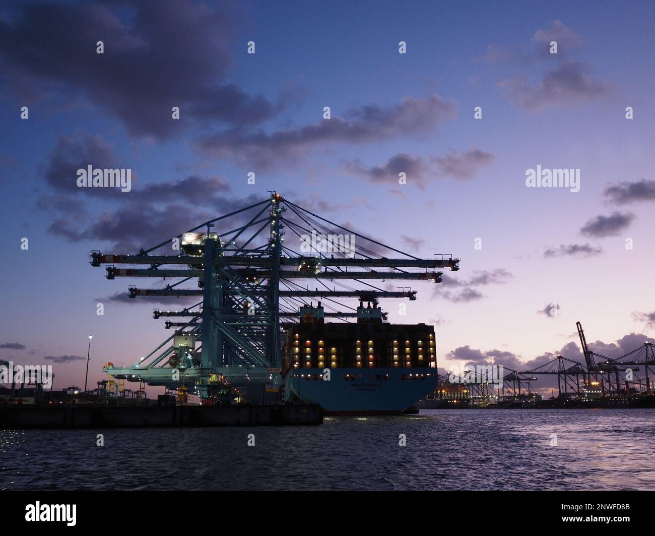 Nightfall in the deep sea port of Rotterdam, the Netherlands with ...