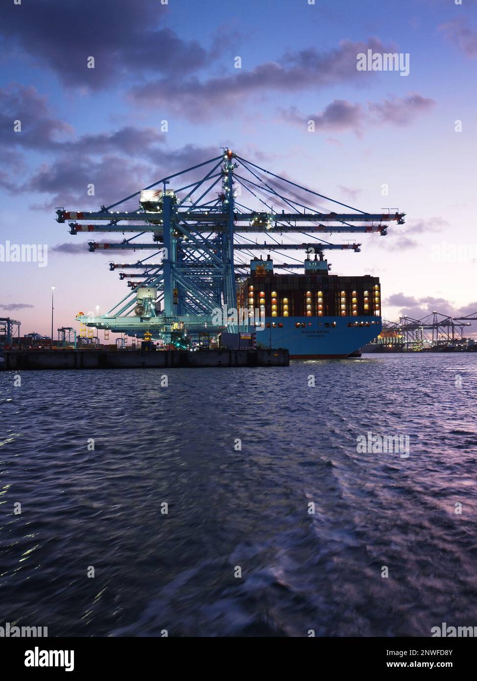 Nightfall in the deep sea port of Rotterdam, the Netherlands with ...