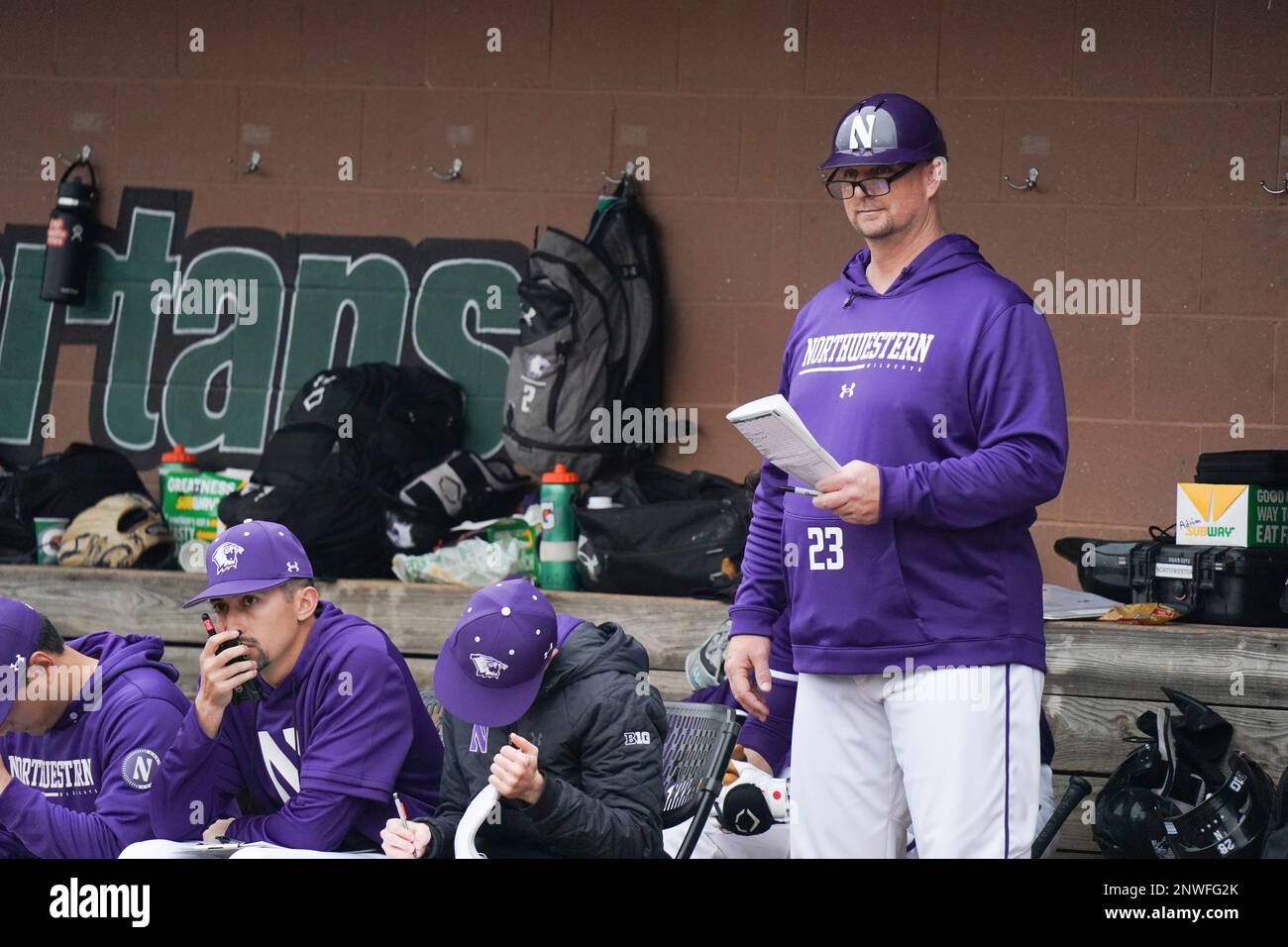 Northwestern head coach Jim Foster looks on from the dugout during an ...