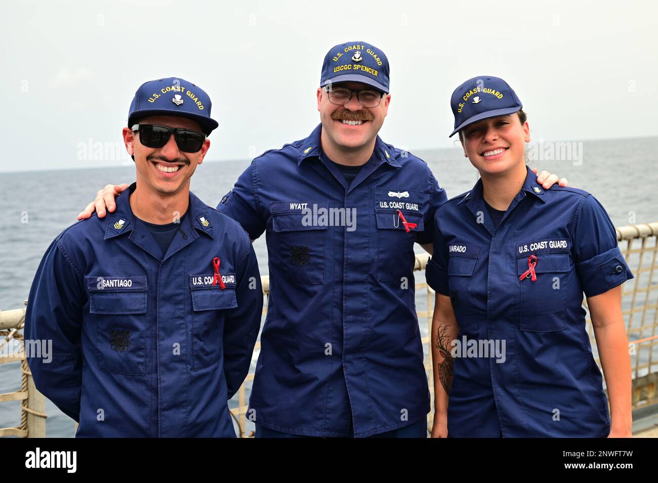 U.S. Coast Guard Petty Officer 1st Class Angel Santiago, left, a ...
