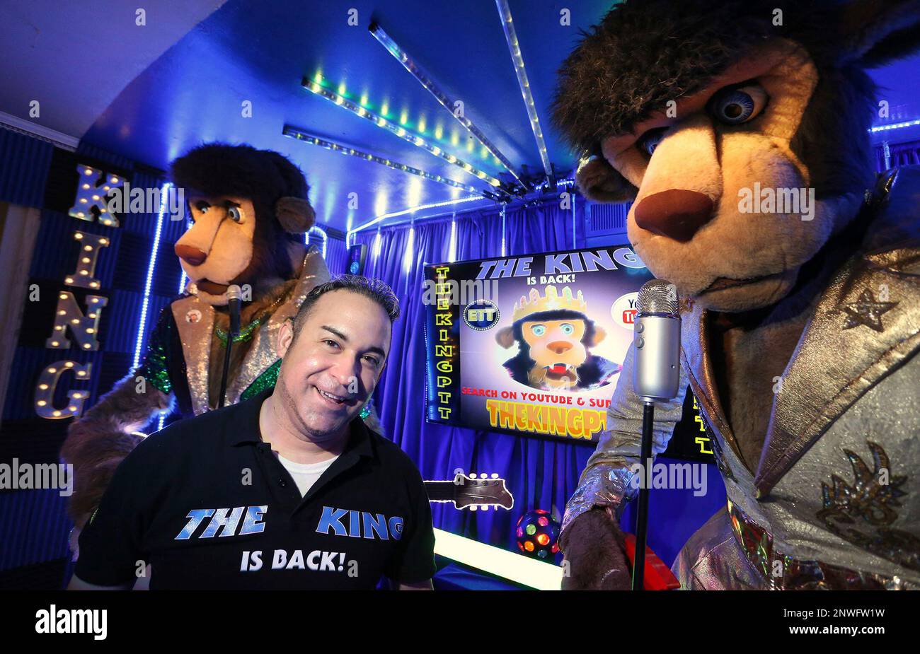 Jared Sanchez, center, poses with The King, left, and King Puff, right ...