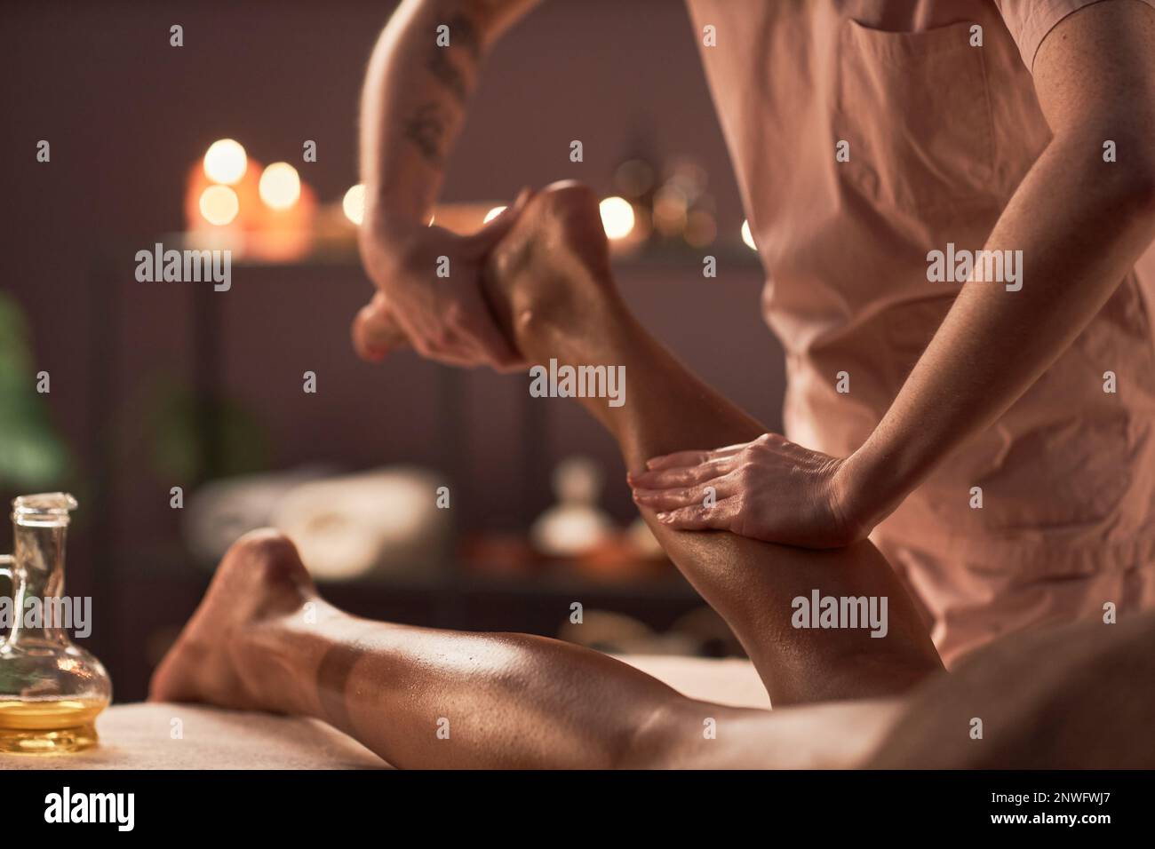 Spa therapist massaging legs of client to release fatigue Stock Photo ...