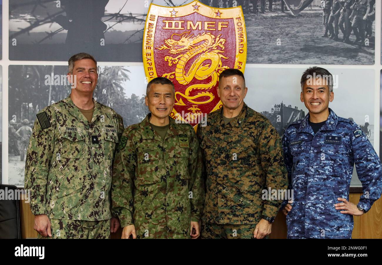 U.S. Navy Rear Adm. Derek Trinque, commander Task Force 76/3, left ...