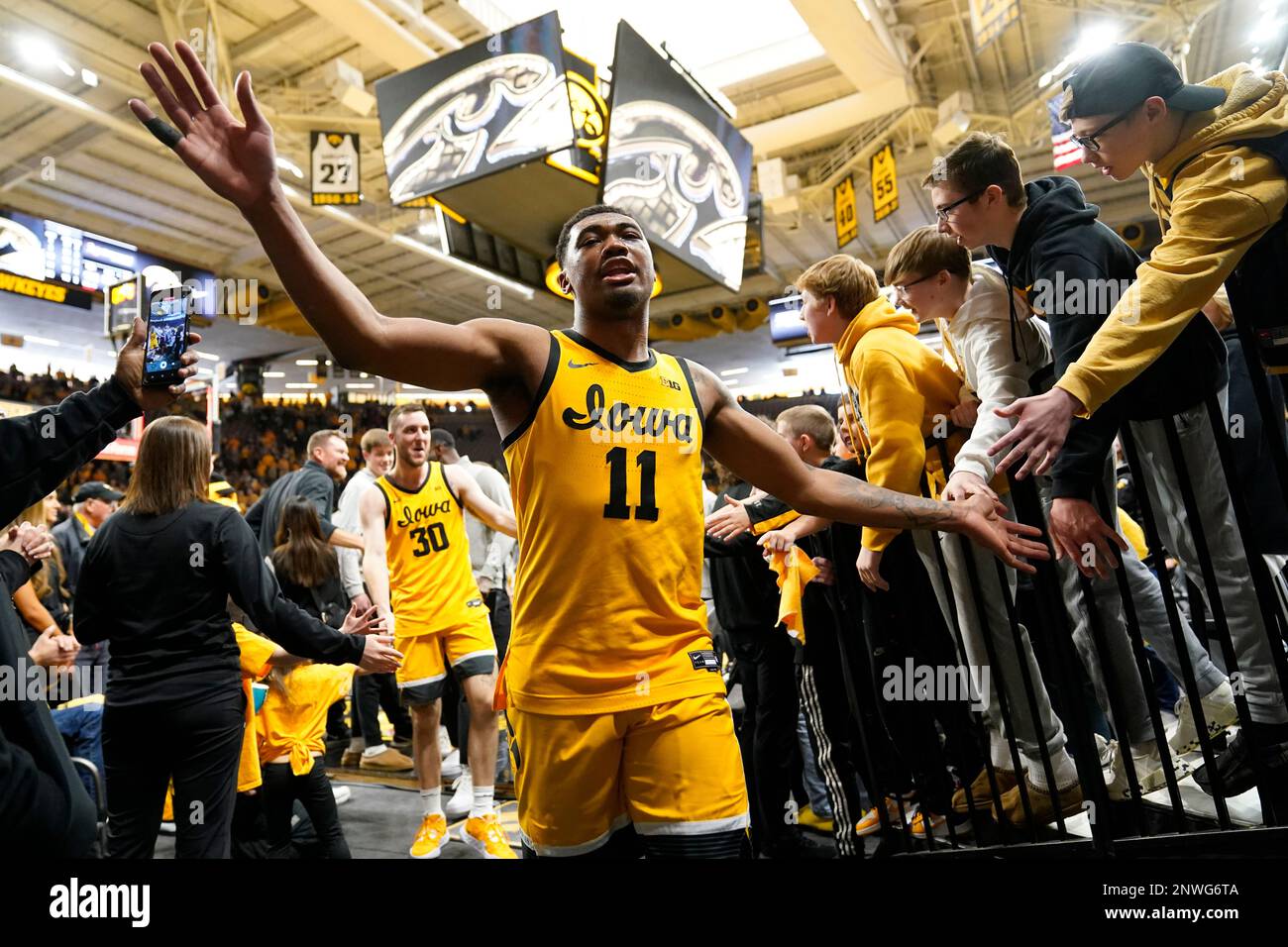 Iowa guard Tony Perkins (11) celebrates with fans after an NCAA college ...