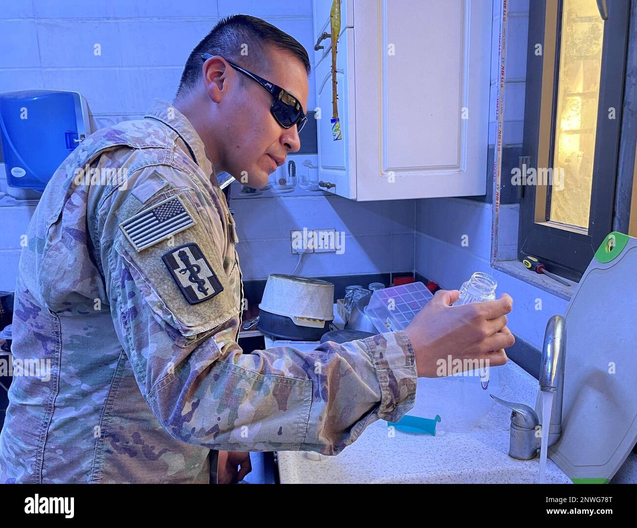 Sgt. Brad Talk, JTF MED 374 Preventative Medicine NCO, acquires a water ...