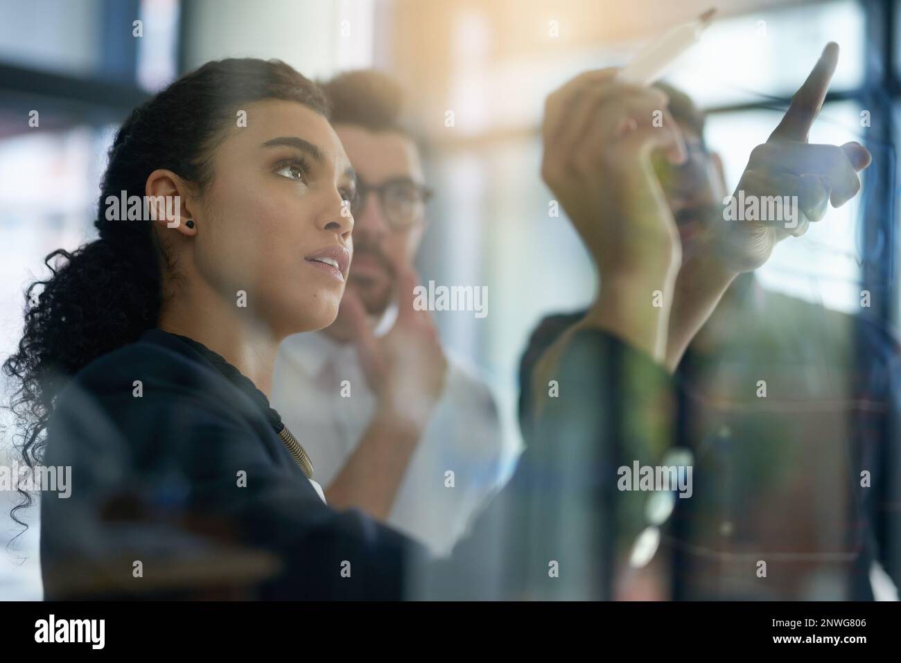 Succeeding is top priority. Shot of a group of colleagues brainstorming ...