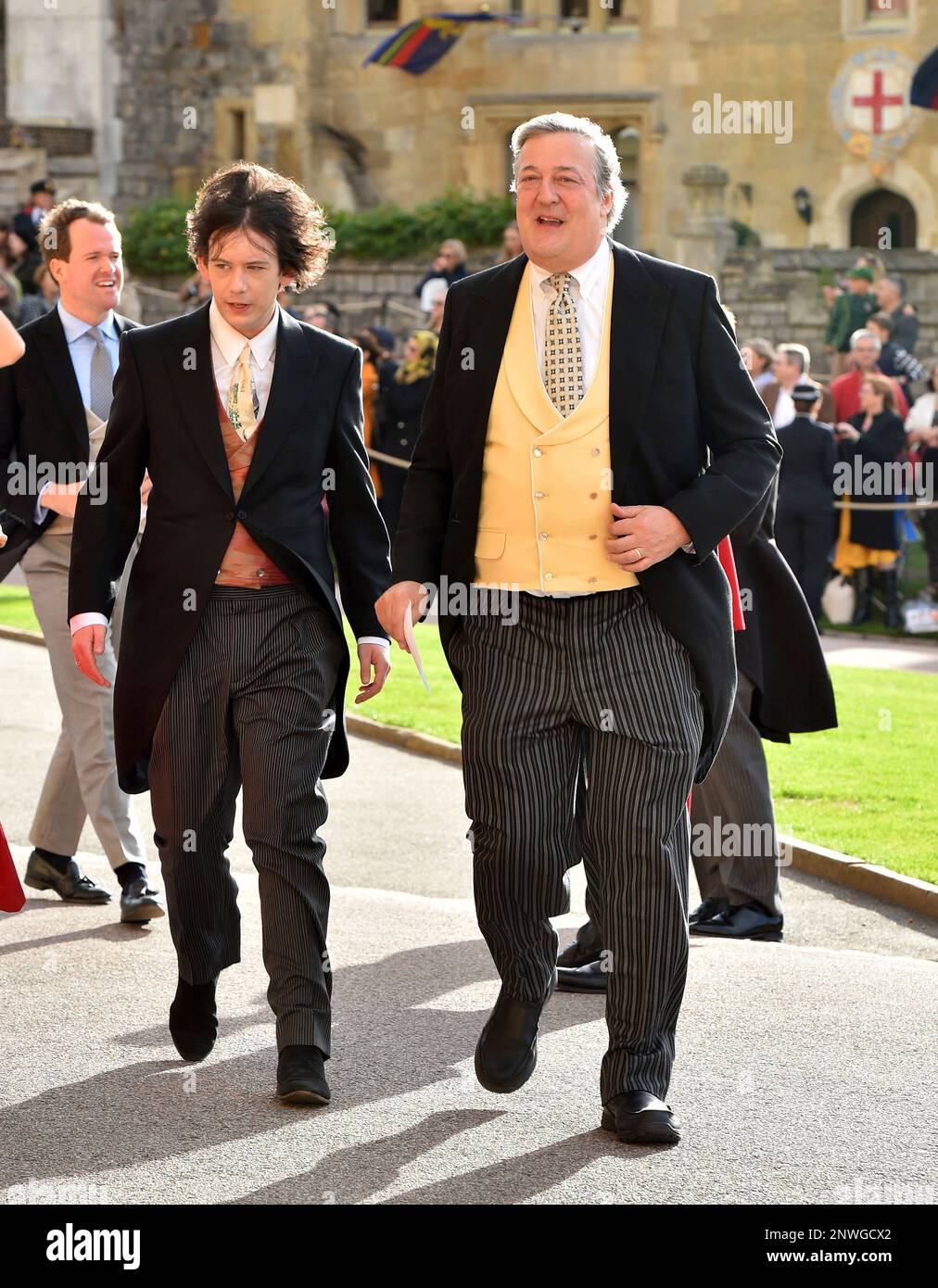 Elliott Spencer, left, and actor Stephen Fry arrive for the wedding of ...
