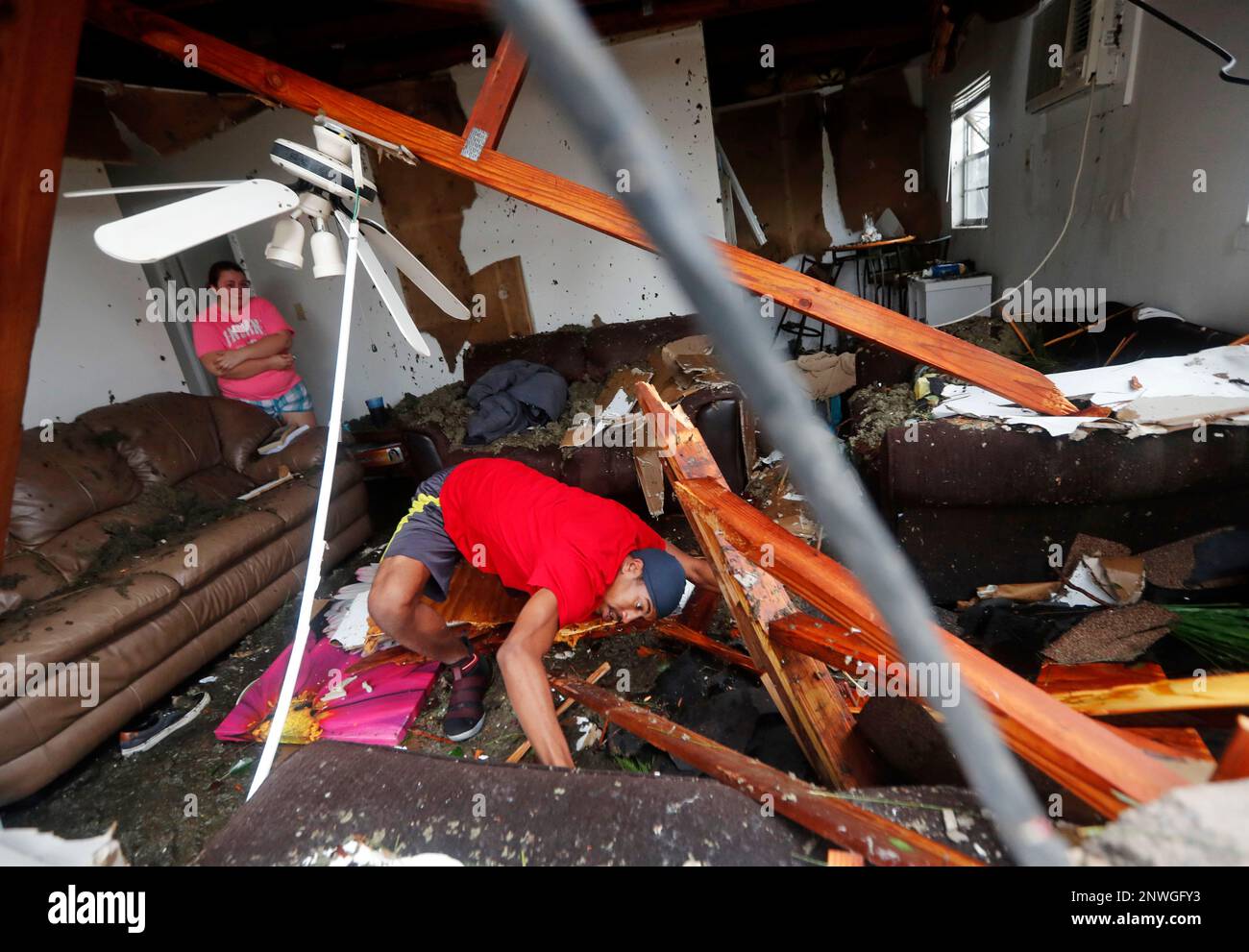 Dorian Carter looks under furniture for a missing cat after several ...