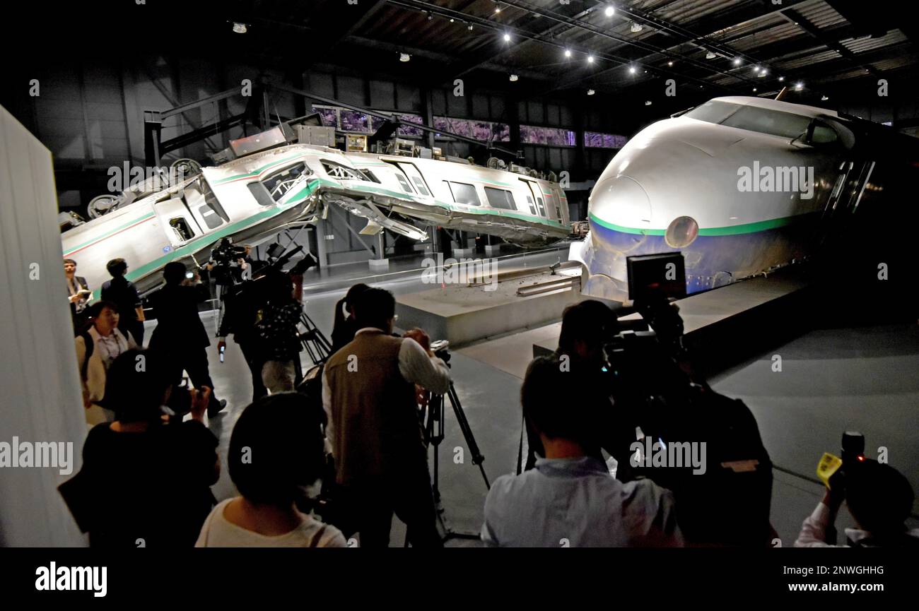 Damaged Joban Line train (L) and Shinkansen bullet train are placed at ...