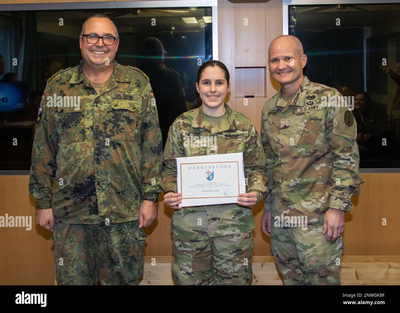 U.S. Army Sgt. Jessica Vaught is presented a certificate from ...