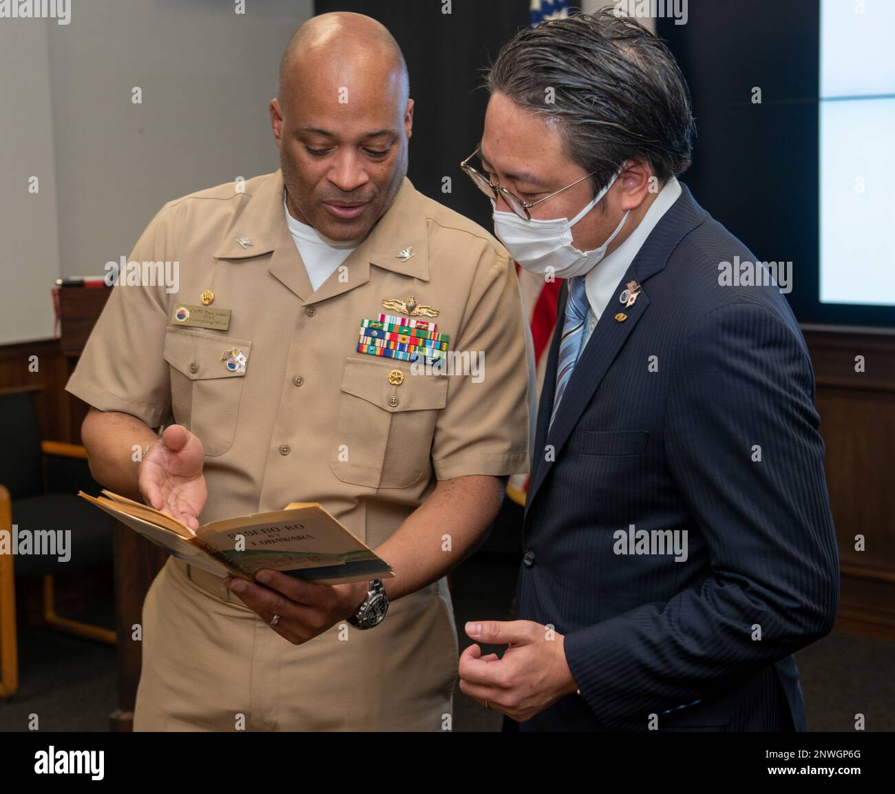 Capt. David Adams, Commander, Fleet Activities Sasebo (CFAS), presents ...