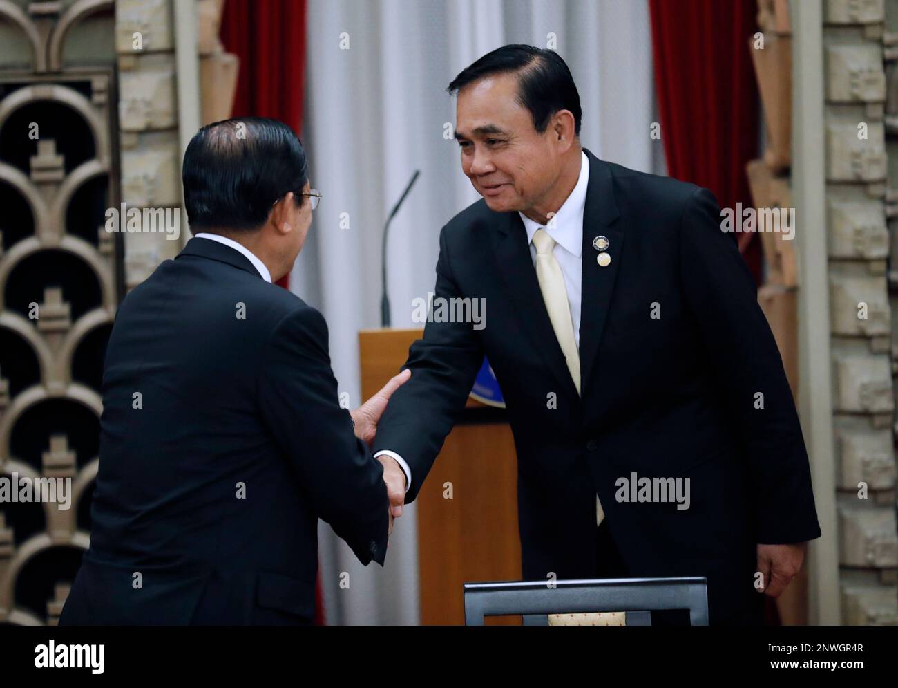 Thai Prime Minister Prayuth Chan-ocha, right, shakes hands with ...