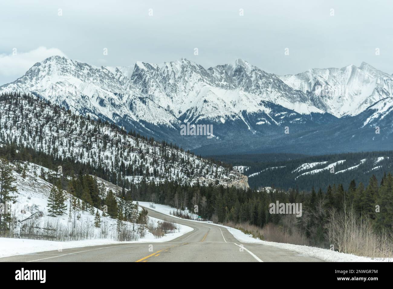 Wilderness road, highway in northern Canada with mountains towering ...