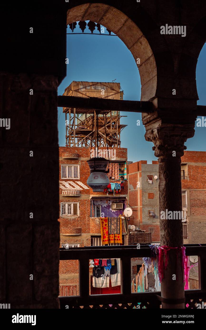 New brick building in frame of ancient building Stock Photo - Alamy
