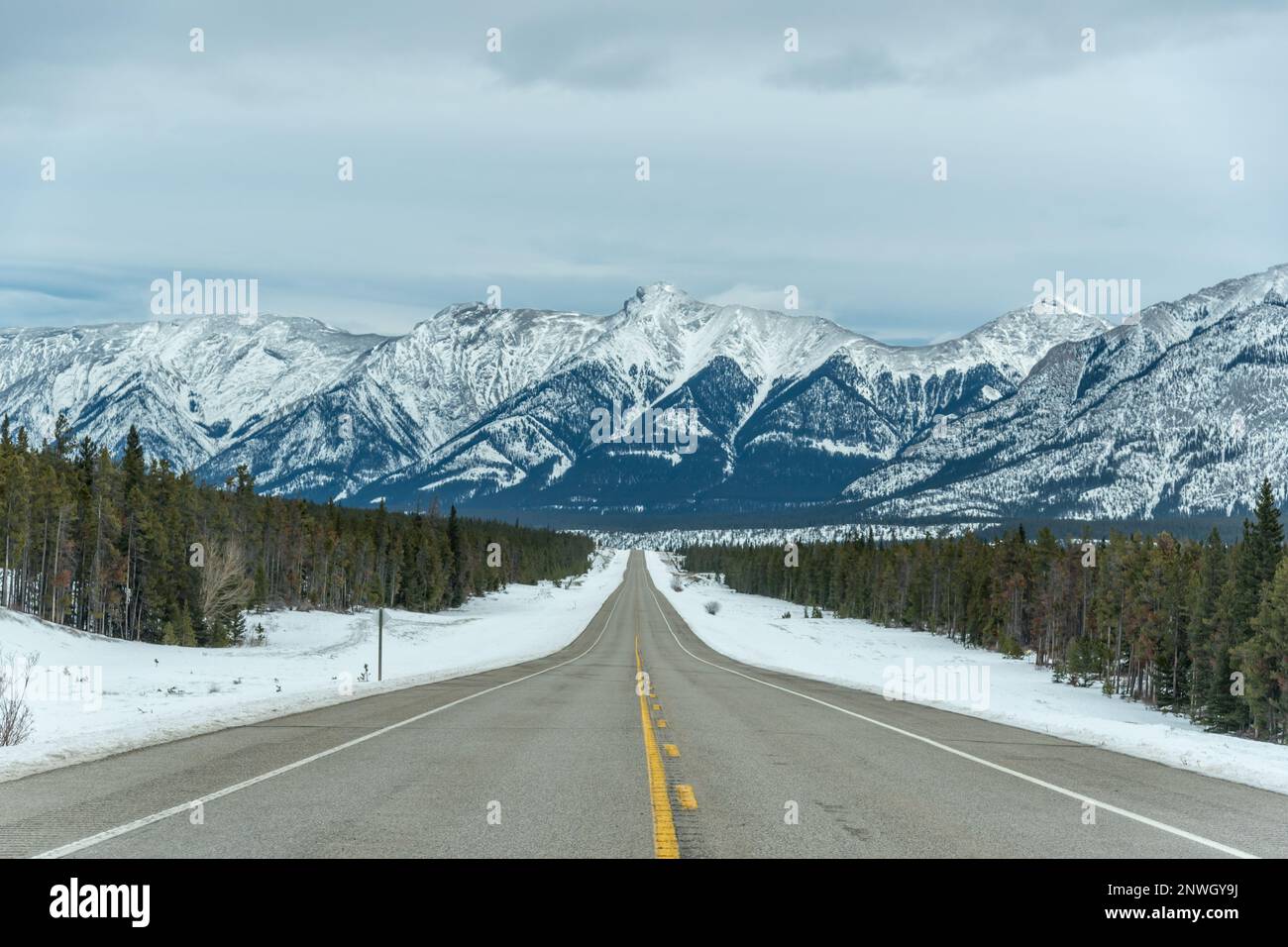 Wilderness road, highway in northern Canada with mountains towering ...
