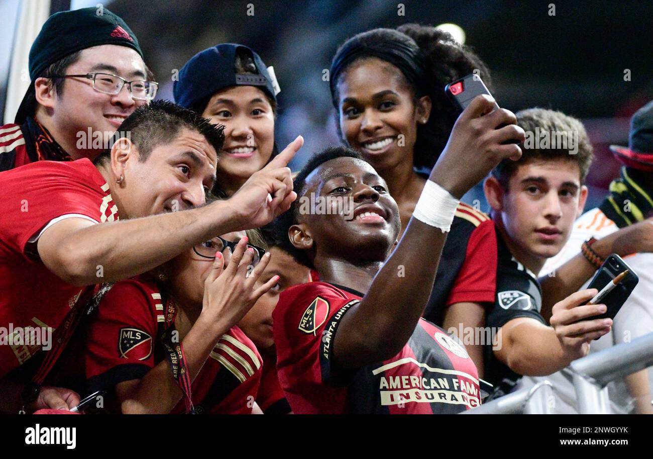 Atlanta United defender George Bello takes a selfie with fans after an ...