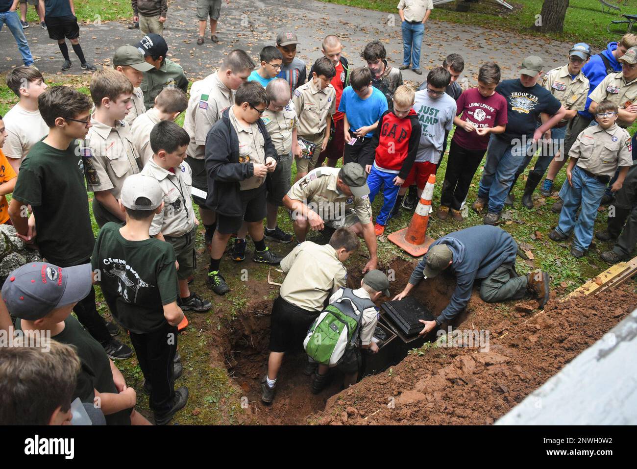 Placing time capsules inside the ground are Jeff Love, Scout Troop 745 ...